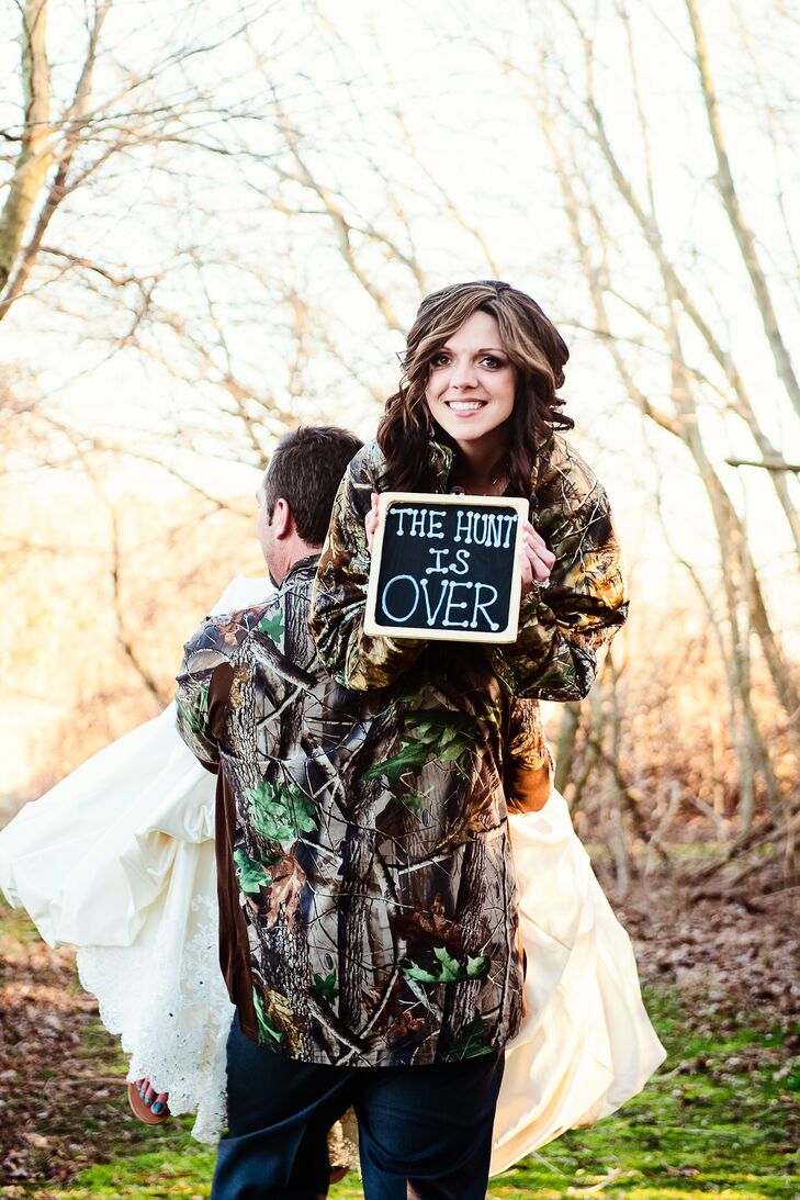 Newlyweds with "The Hunt is Over" Sign