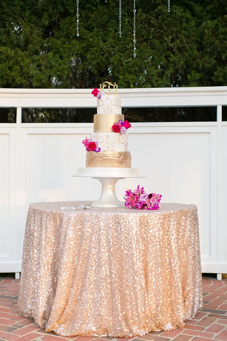 Gold-Accented Wedding Cake with Vibrant Flowers