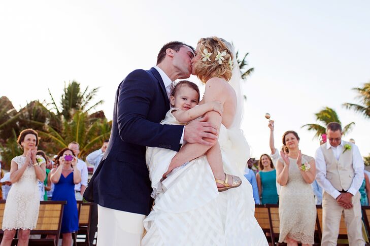 Carrie and Nick Holding Child for First Kiss