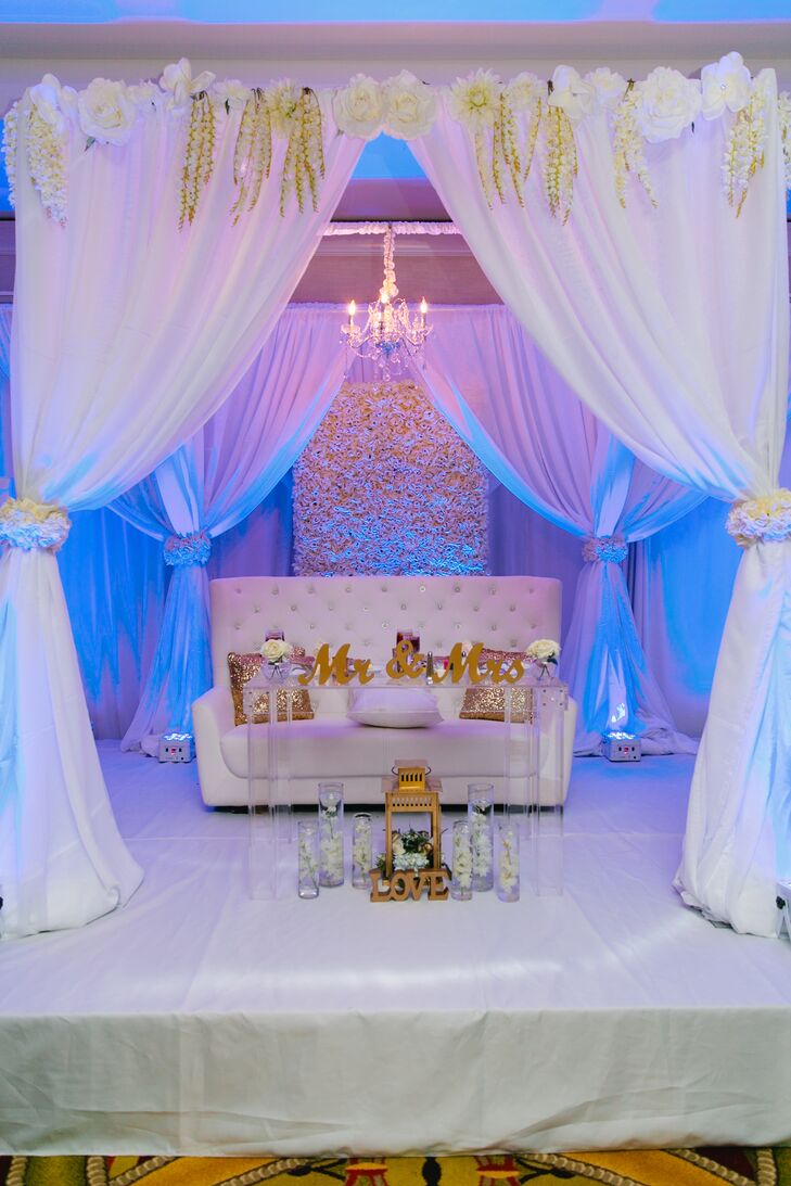 Romantic, Elevated Sweetheart Table Area with Draping and Uplighting