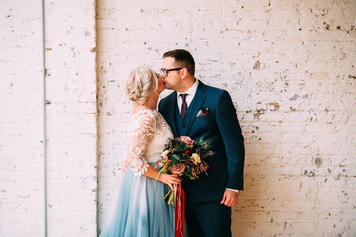 Groom in Classic Blue Suit and Bride Wearing Elegant Dress with Blue Skirt