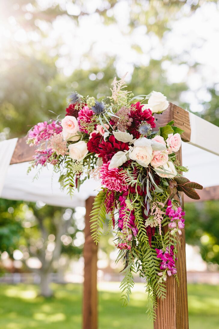 Rustic Chuppah With Bright Pink, Red and Blush Flowers