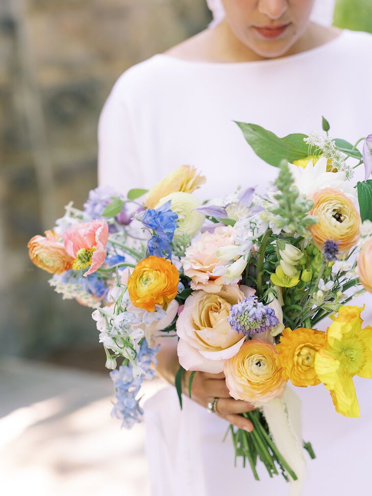 Bride in Modest Wedding Gown Holding Colorful, Springtime Bouquet