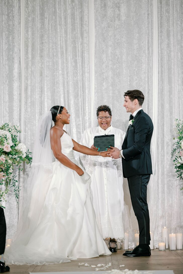 Bride and Groom at Altar With White Draping Backdrop, Candles and ...