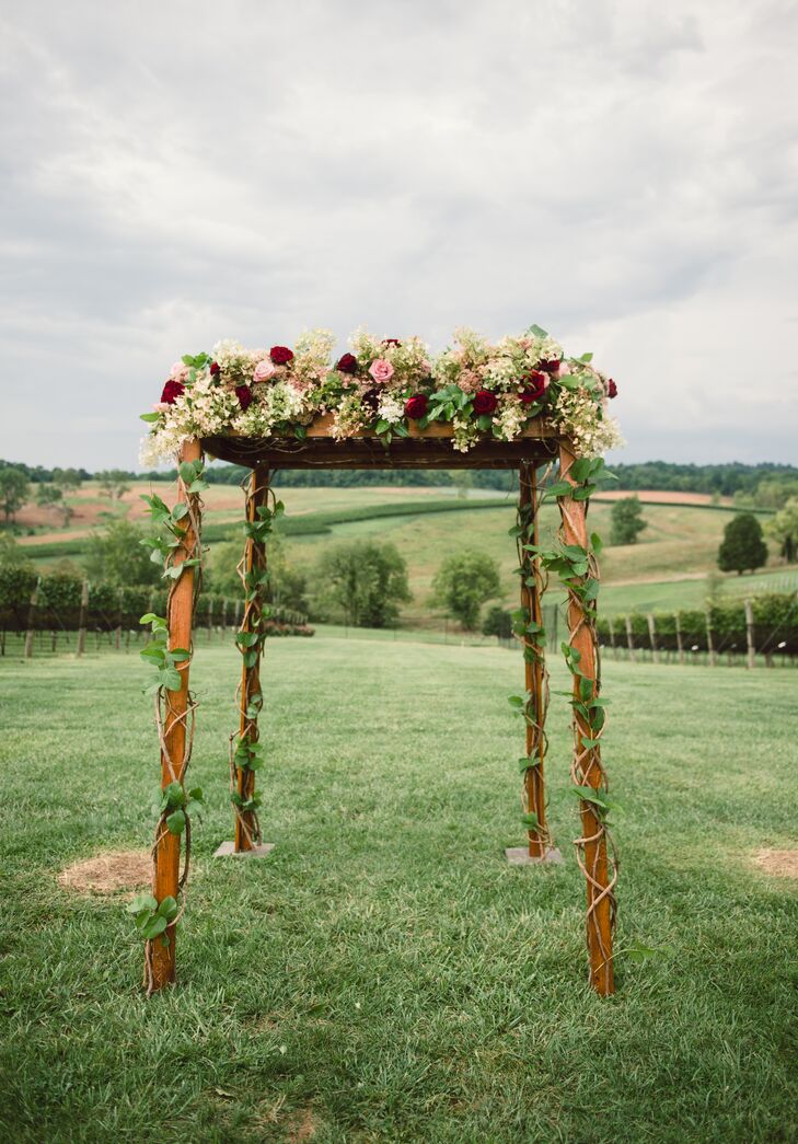 Wood Frame Chuppah with Burgundy and Pink Flowers and Vines